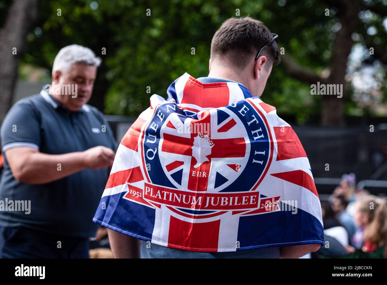 Party reveler wrapped in a large flag seen during the Queen Elizabeth ...