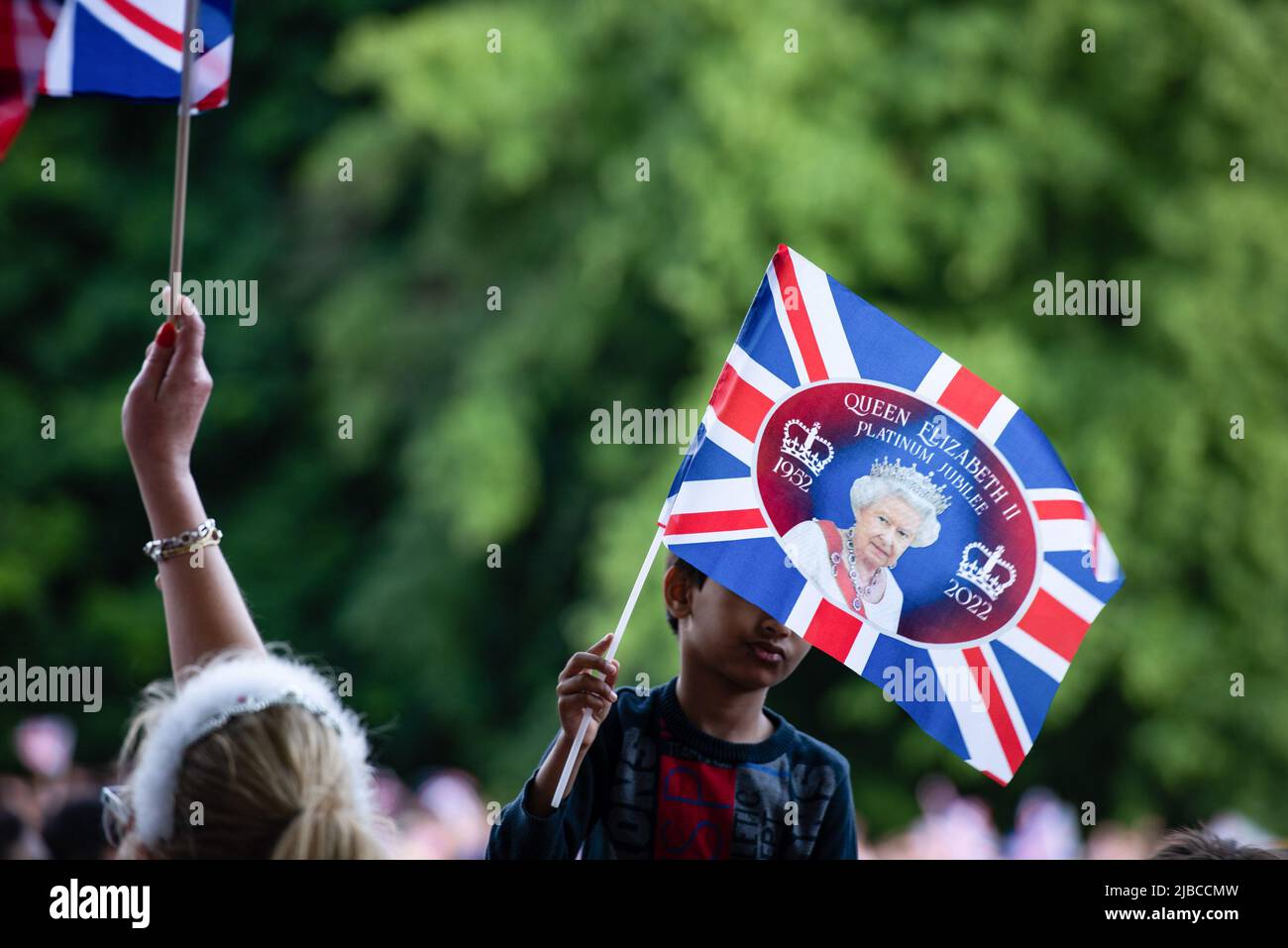 Party revelers hold the British Flags during the Queen Elizabeth II ...