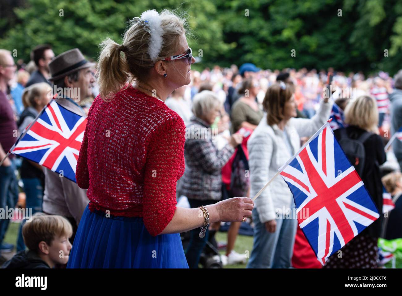 Party revelers hold the British Flags during the Queen Elizabeth II ...