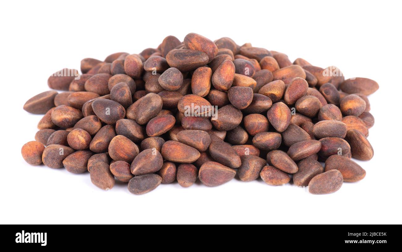 Pine nuts isolated on white background. Pine cones and heap of roasted ...