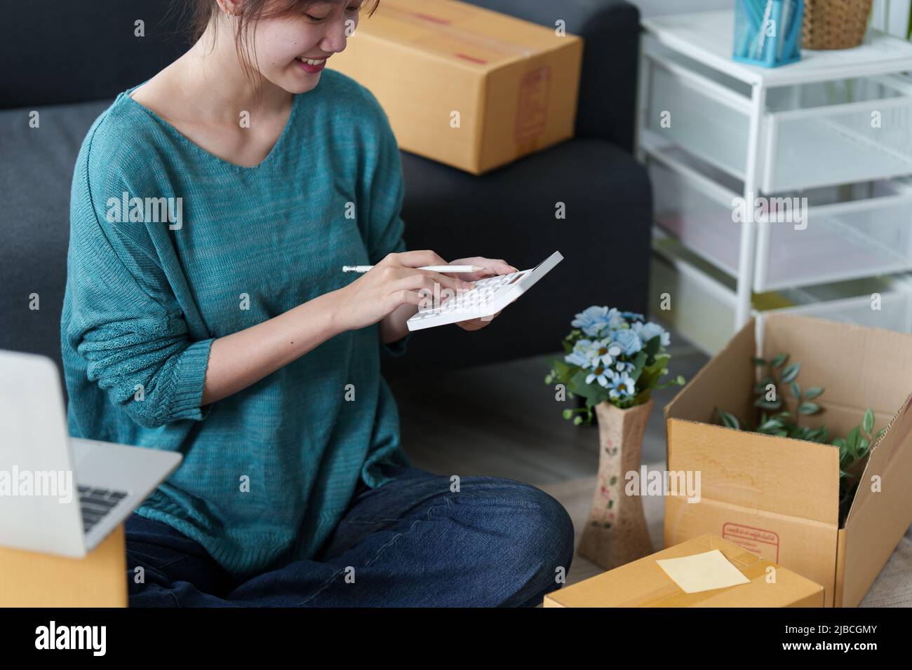 Asian small business owner working at home office. Business retail ...