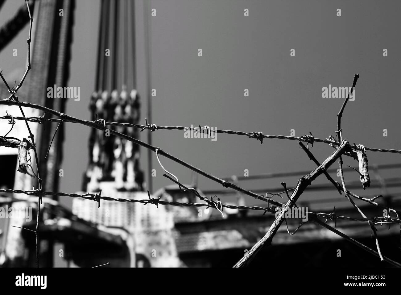 Razor sharp barbed wire fence protecting the industrial area in black ...