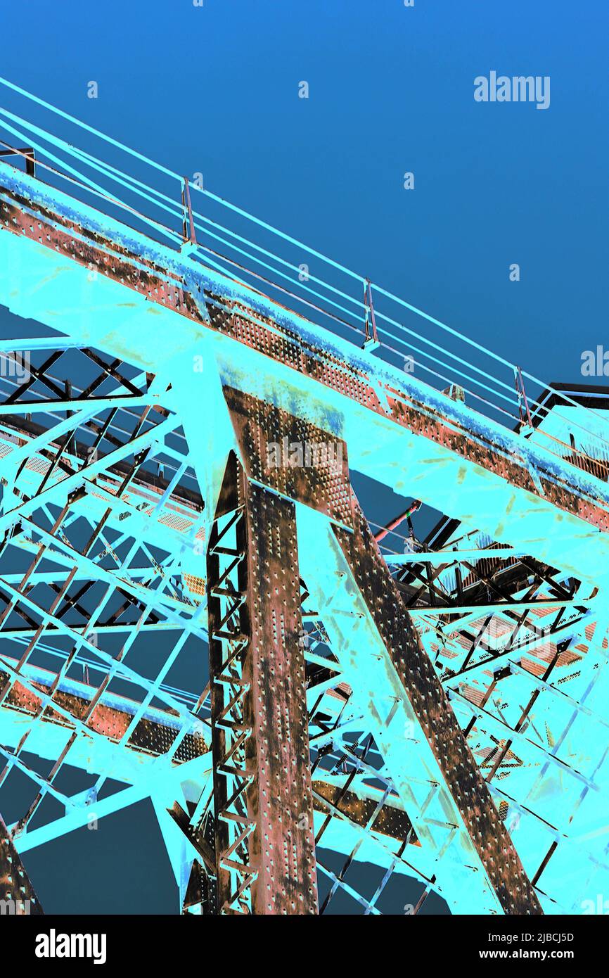 A very tall steel truss structure standing in the industrial district ...