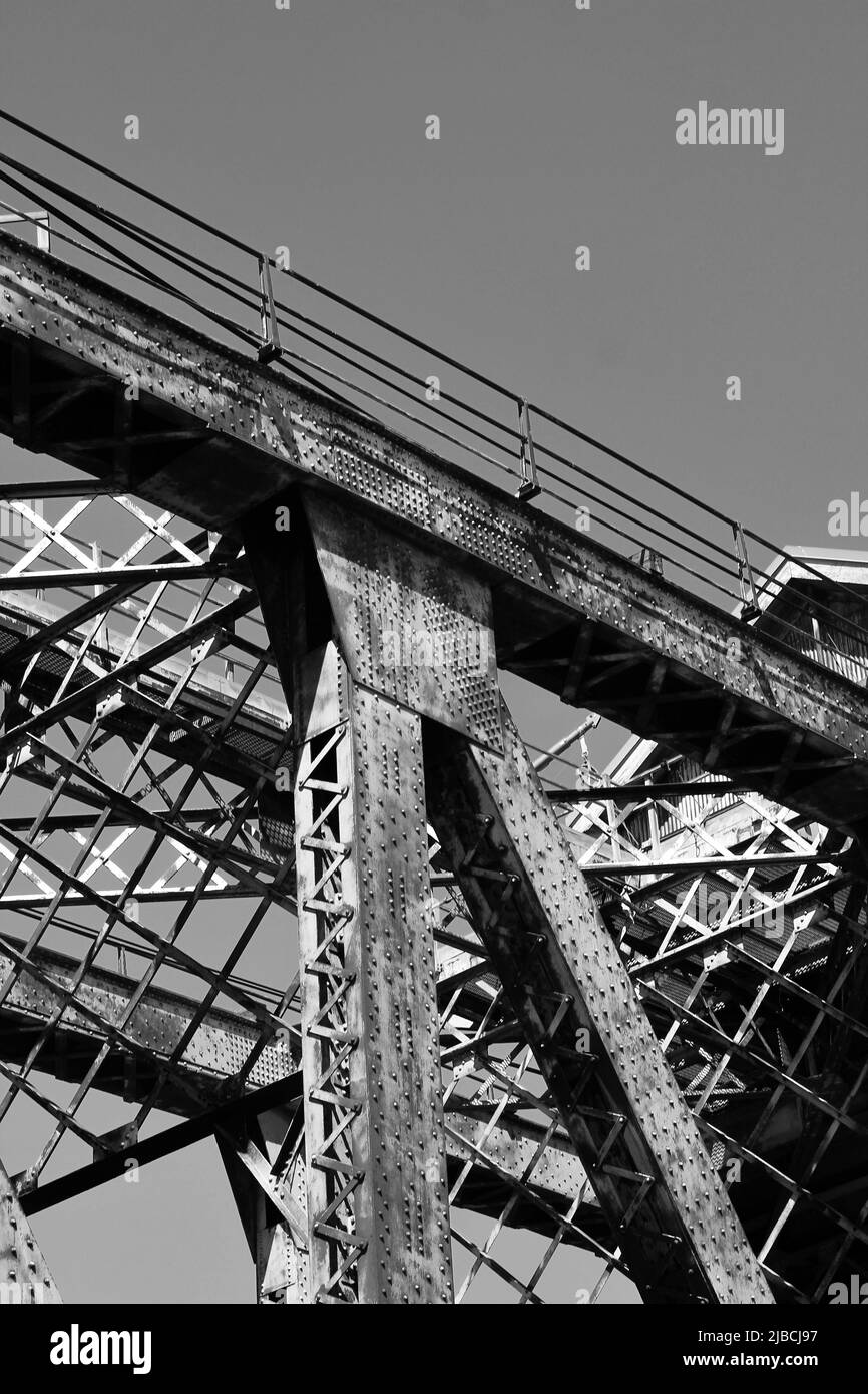 A very tall steel truss structure standing in the industrial district ...