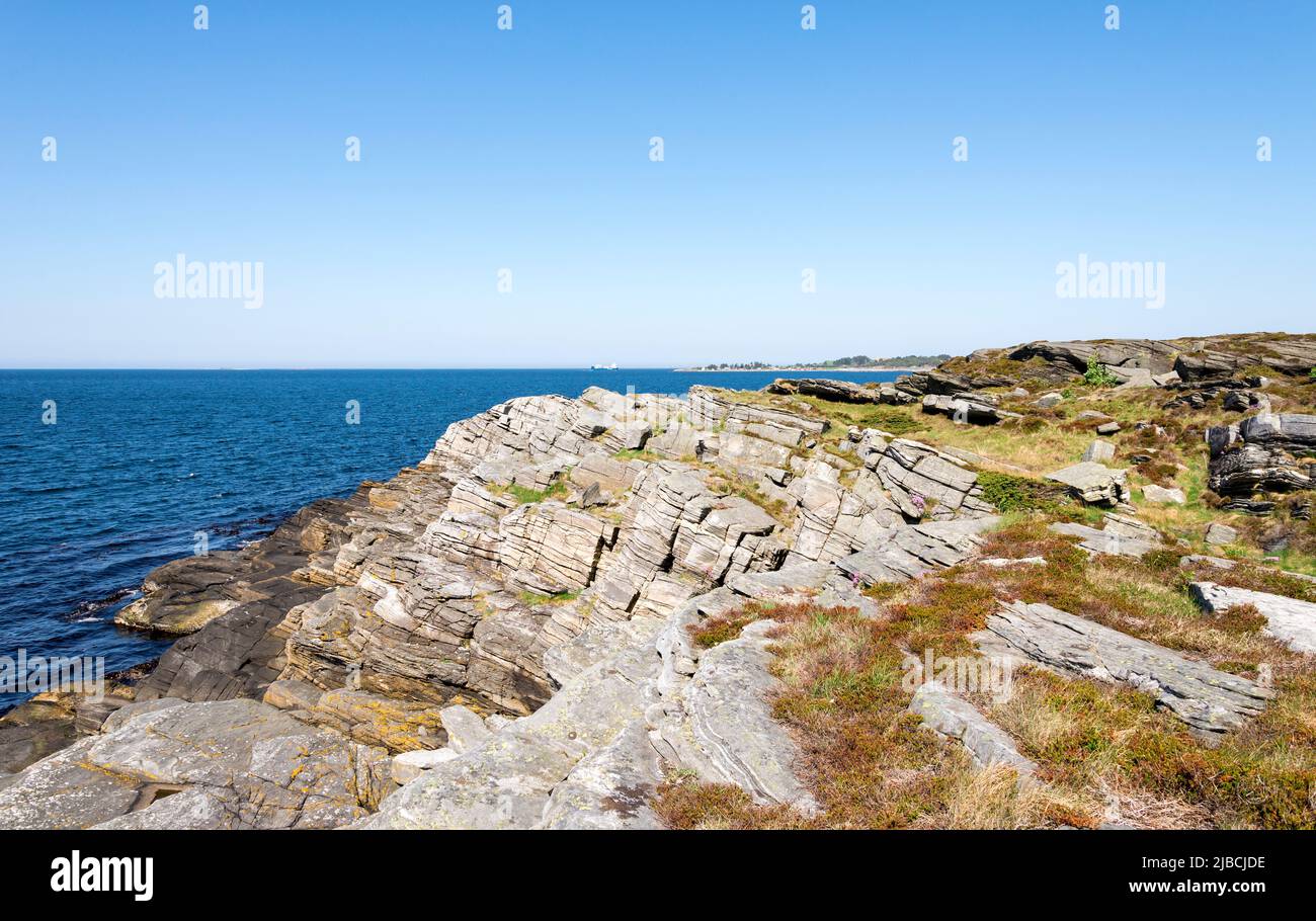 Scenic coastal landscape with geological formation layers in Kvernevik ...