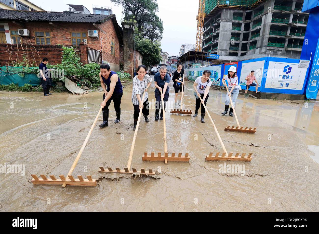 LIUZHOU, CHINA - JUNE 5, 2022 - People clean silt from a riverbank in ...