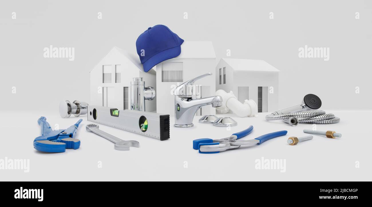 plumbing service, components and plumber work tools on desk with model ...
