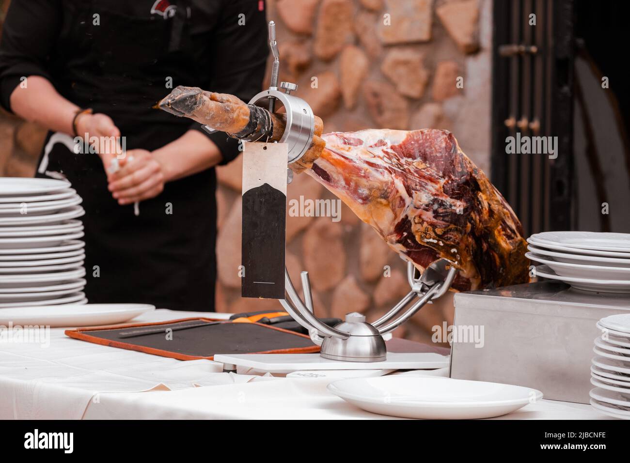 An Iberian ham on a catering table for an event next to the ...