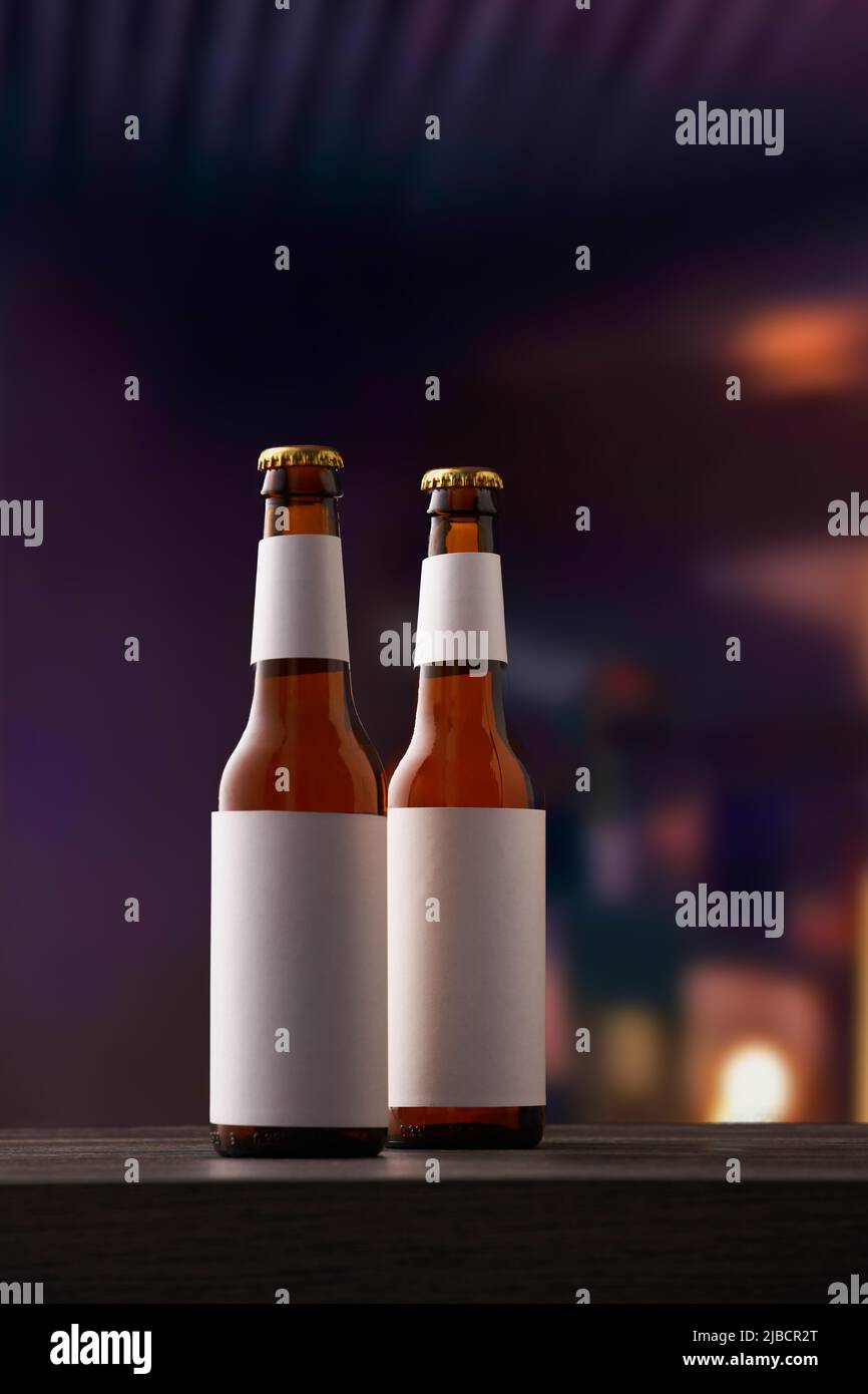 Two bottle of beer on counter in pub. Alcoholic beverage over pub ...
