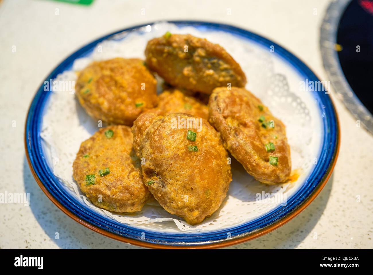 A delicious Chinese dish, fried pork and lotus root cake Stock Photo ...
