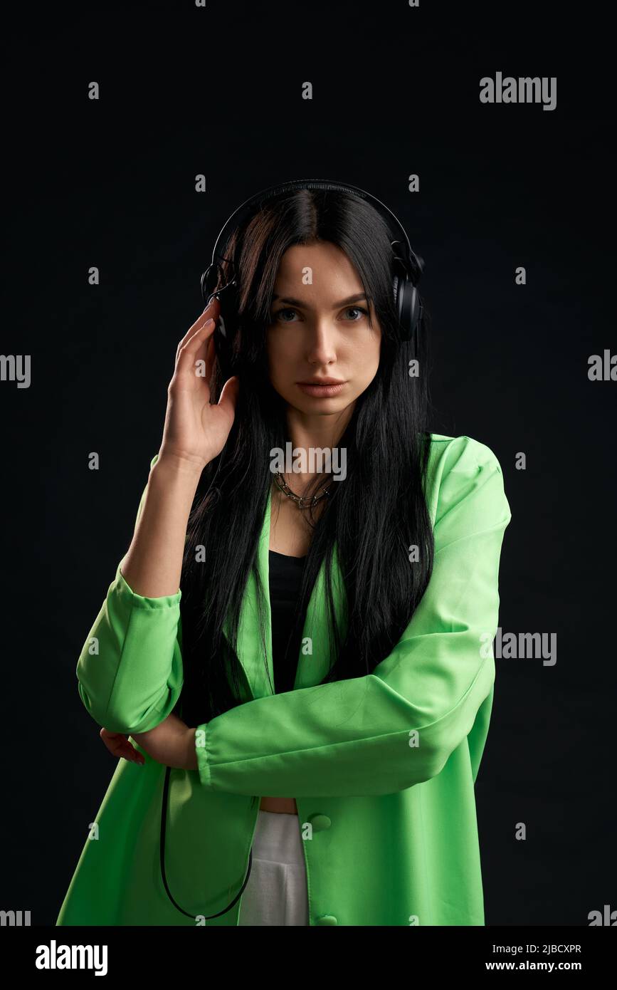 Gorgeous lady with headphones looking in camera with expressive look ...