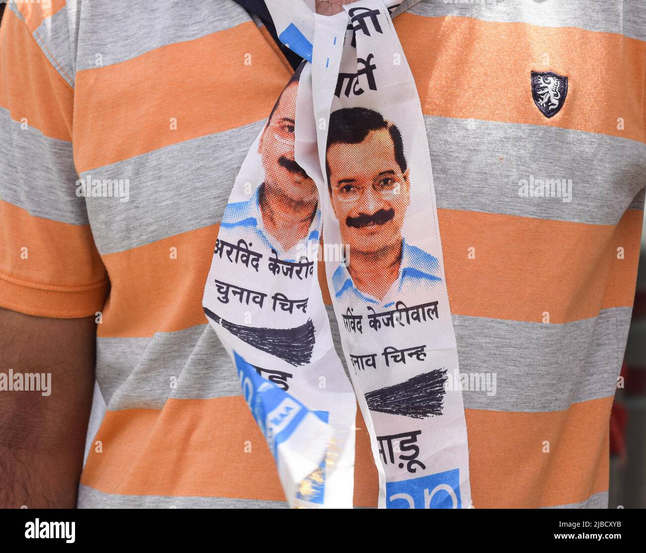 A man wears a scarf of a picture of Delhi CM Arvind Kejriwal at a ...