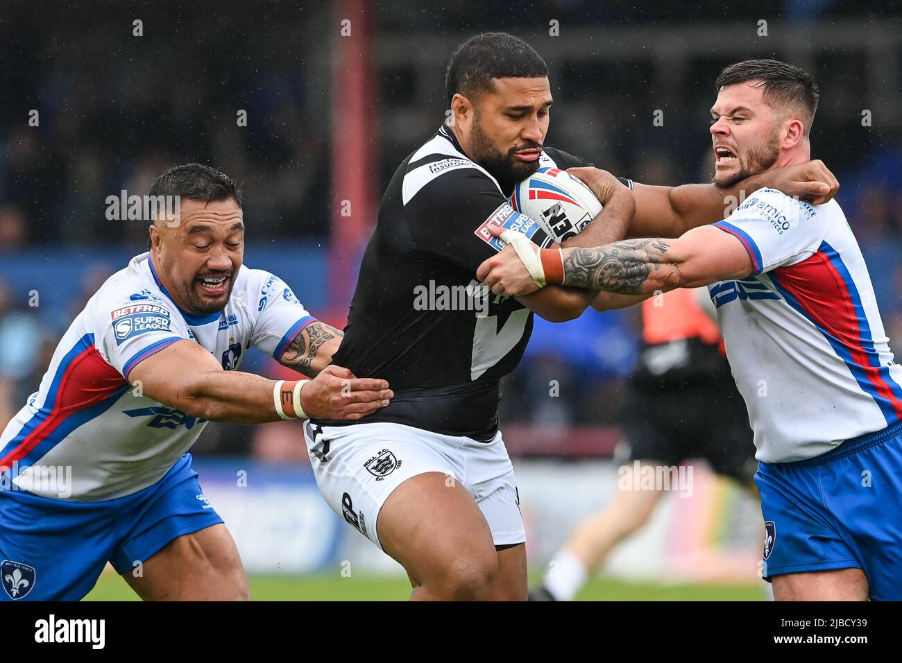 Chris Satae (10) of Hull FC is tackled by Liam Hood (9) and Tinirau ...