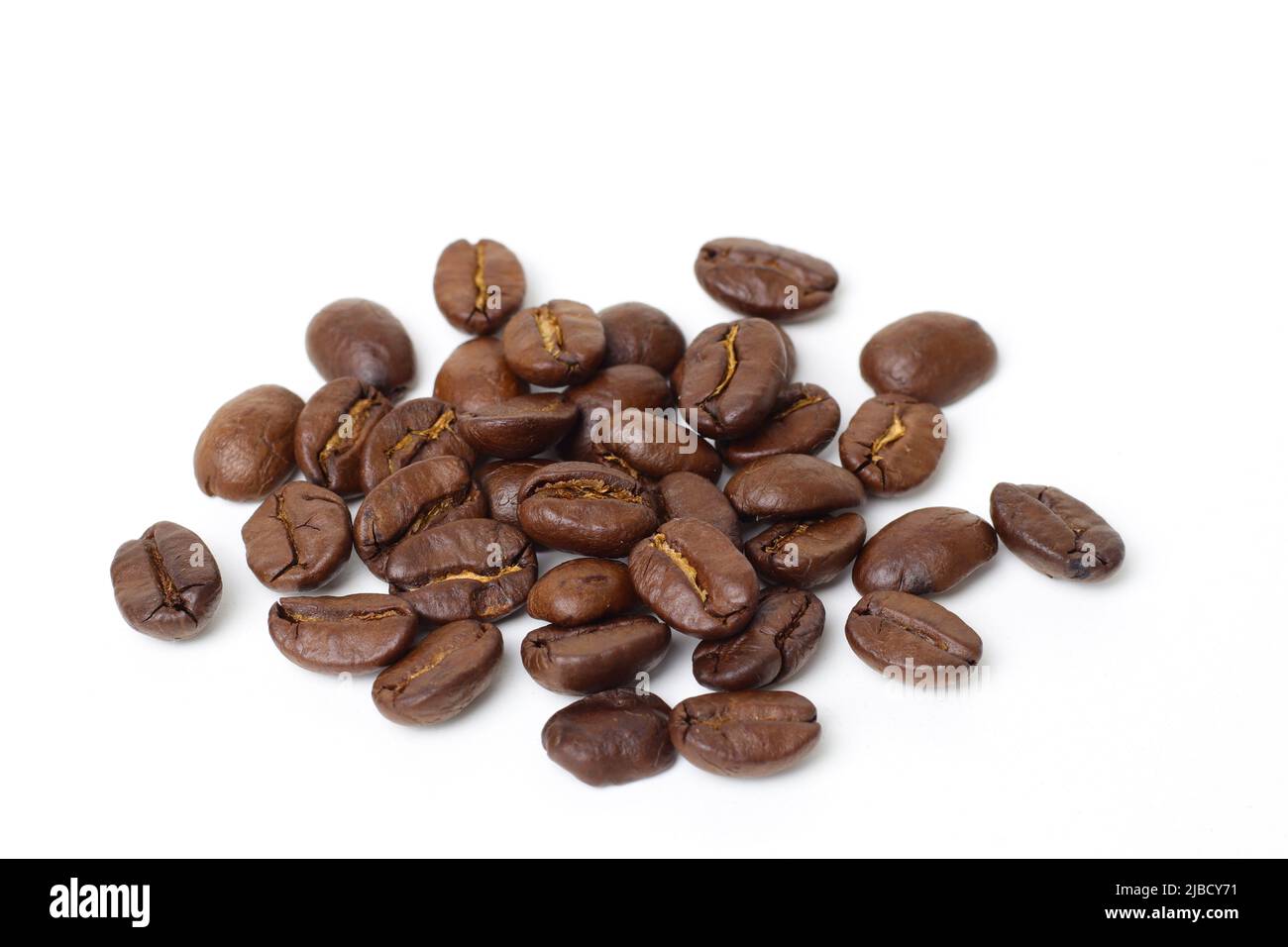 Roasted coffee beans on white. Brown roasted coffee beans isolated on ...