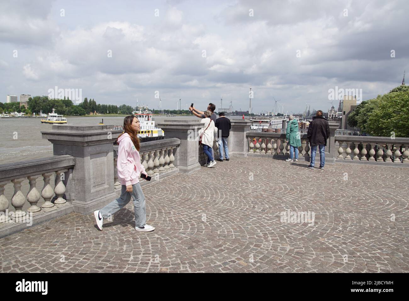 The elevated Zuiderterras near the river Scheldt (Schelde). Tourists ...