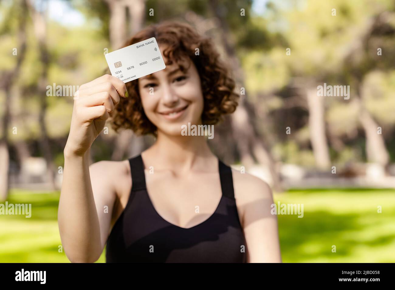 Cute caucasian woman wearing black sports bra standing on city park ...