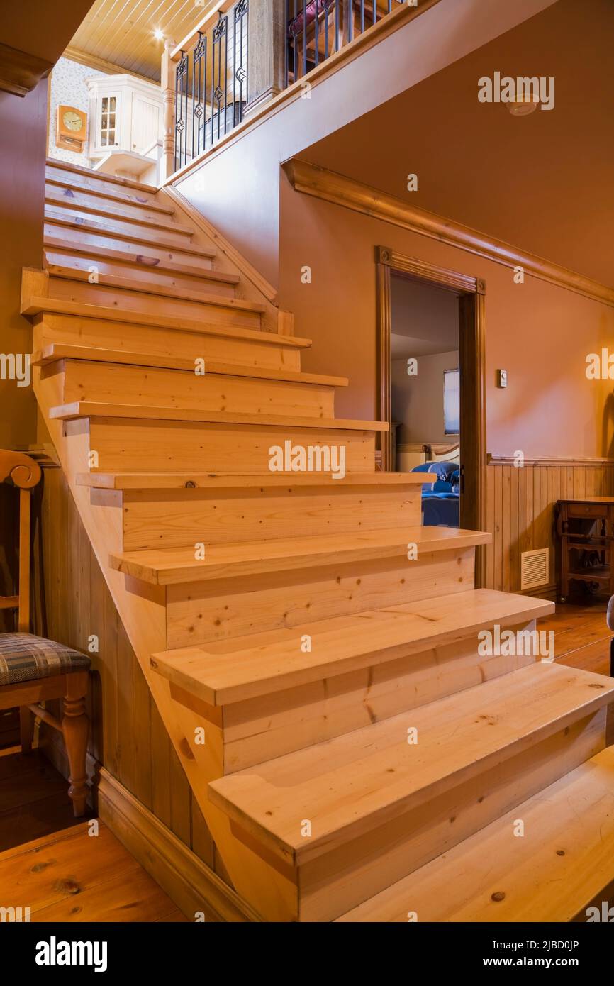 Clear varnished pine wood stairs in basement room inside replica of old ...