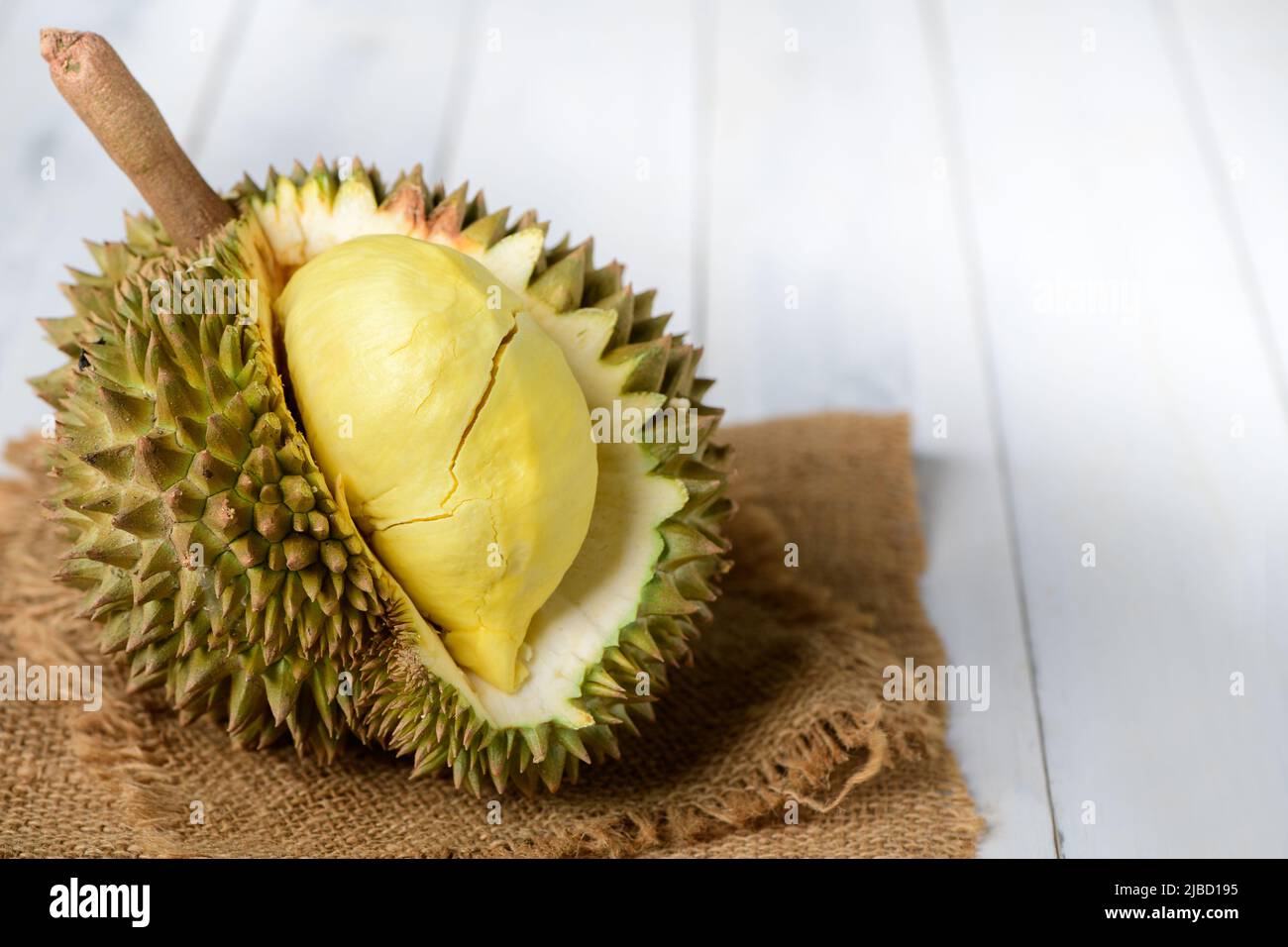 Fresh durian (monthong) on sack and old wood background, king of fruit from Thailand on summer ...