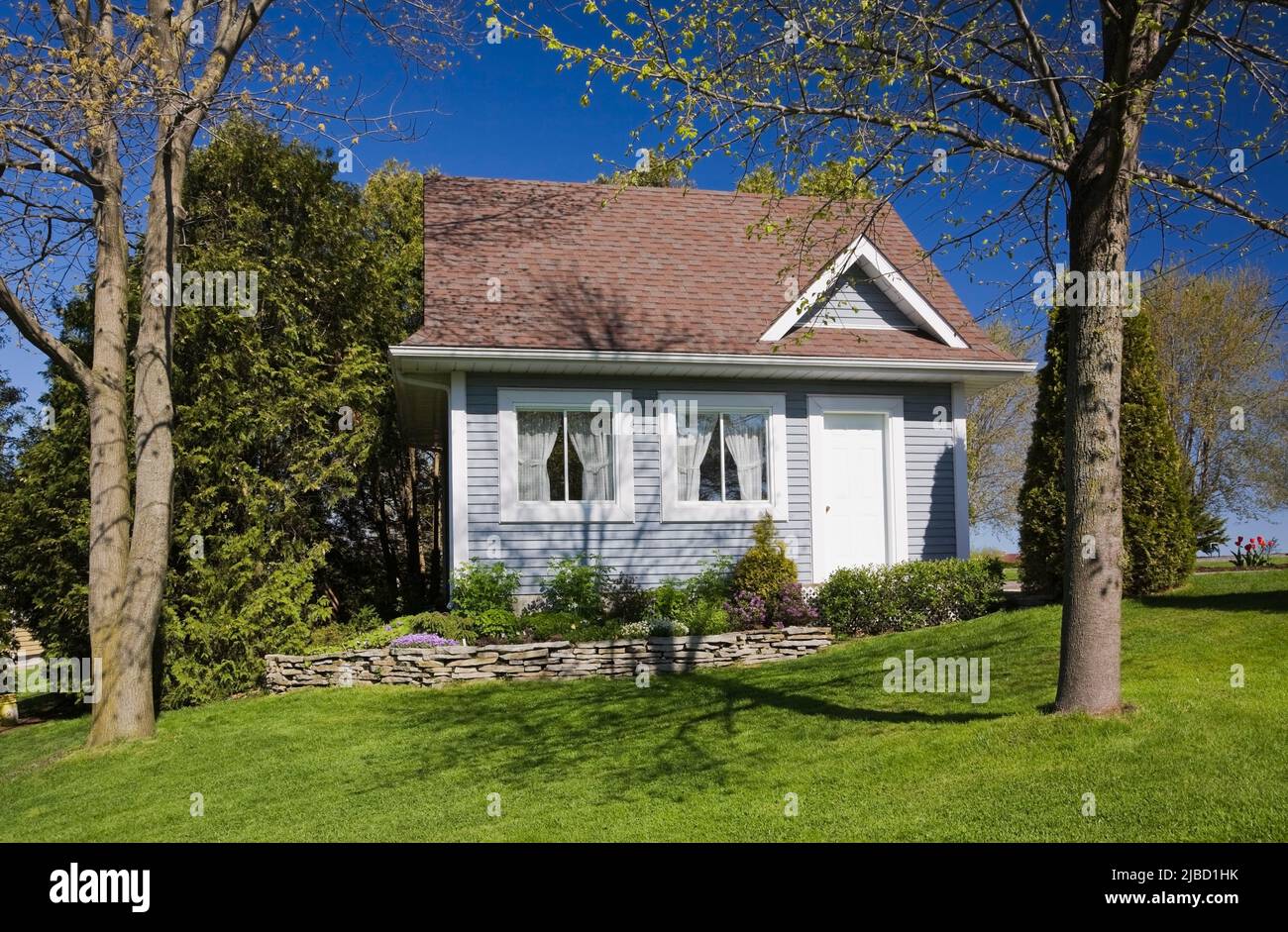 Small home with blue clapboard cladding, white trim, rust colored ...