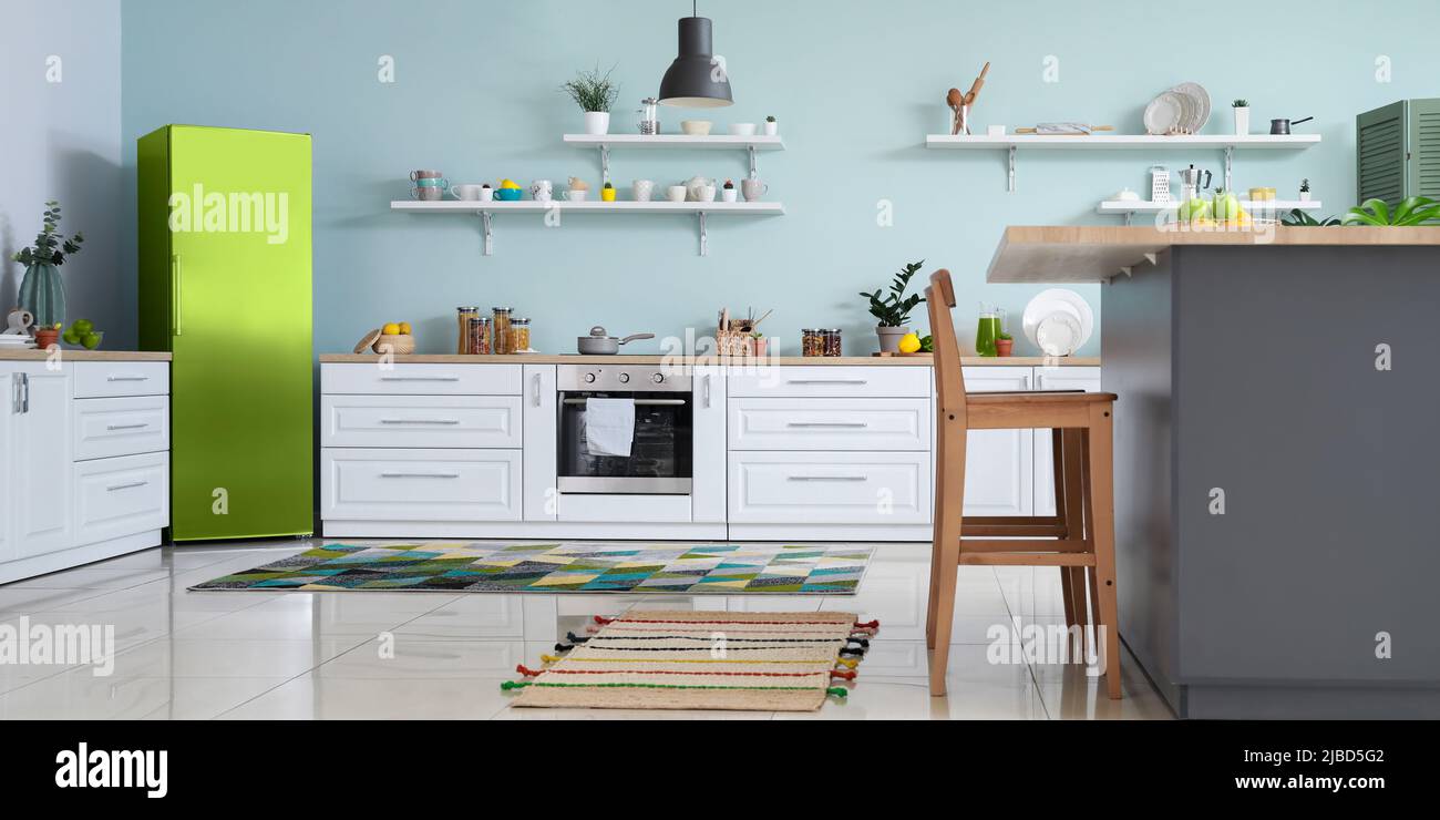 Interior of modern comfortable kitchen with green fridge Stock Photo ...