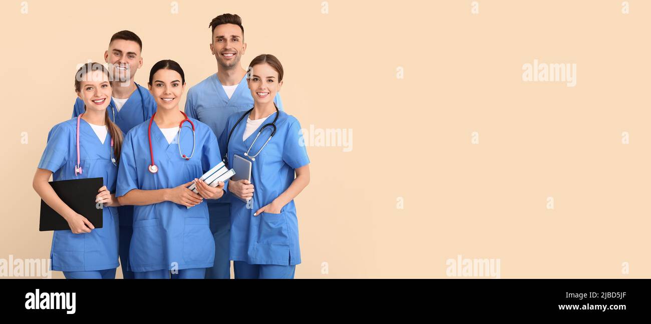 Group of medical students on light color background with space for text ...