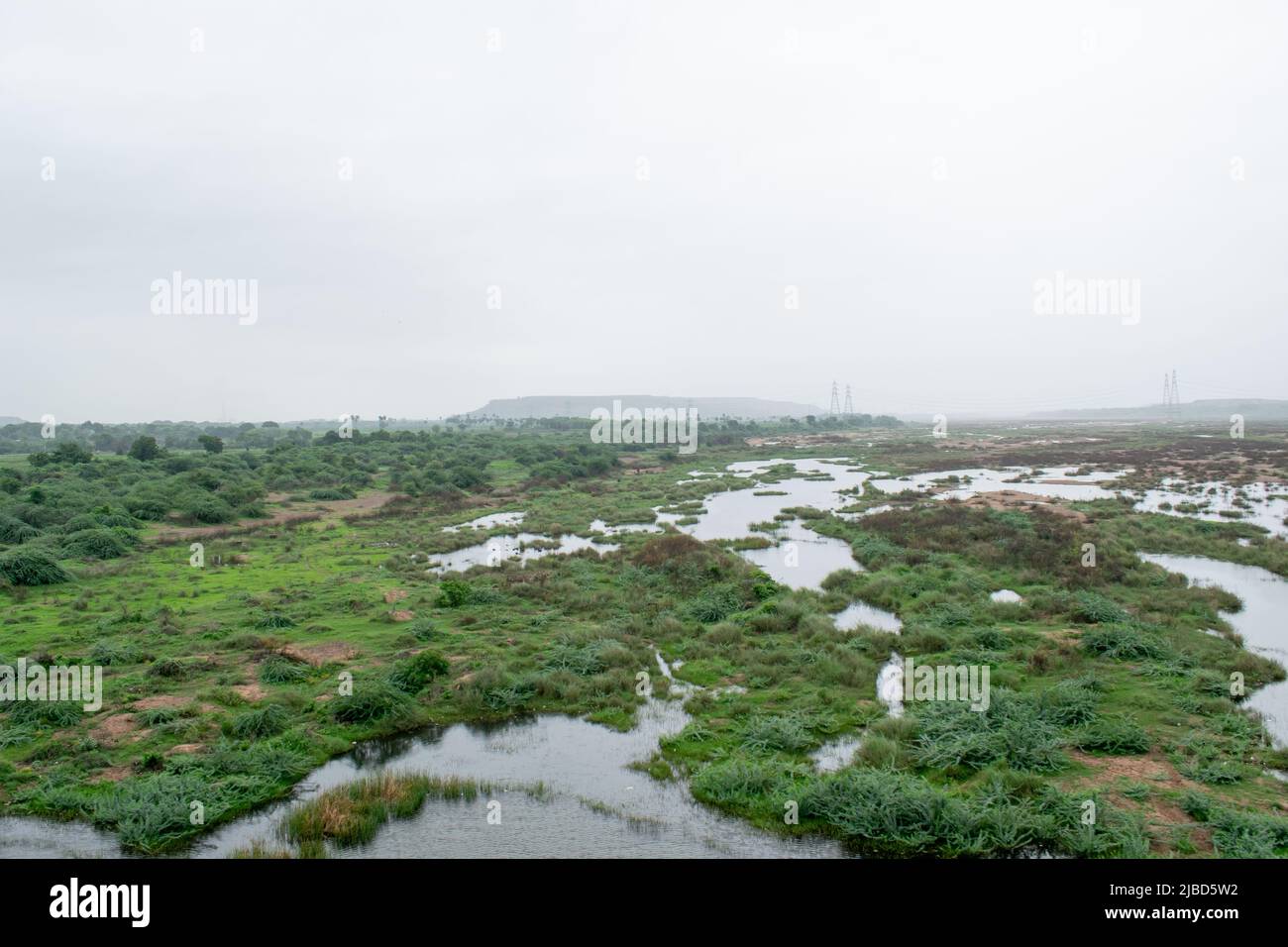 Water is flowing through the land due to small flood Stock Photo - Alamy
