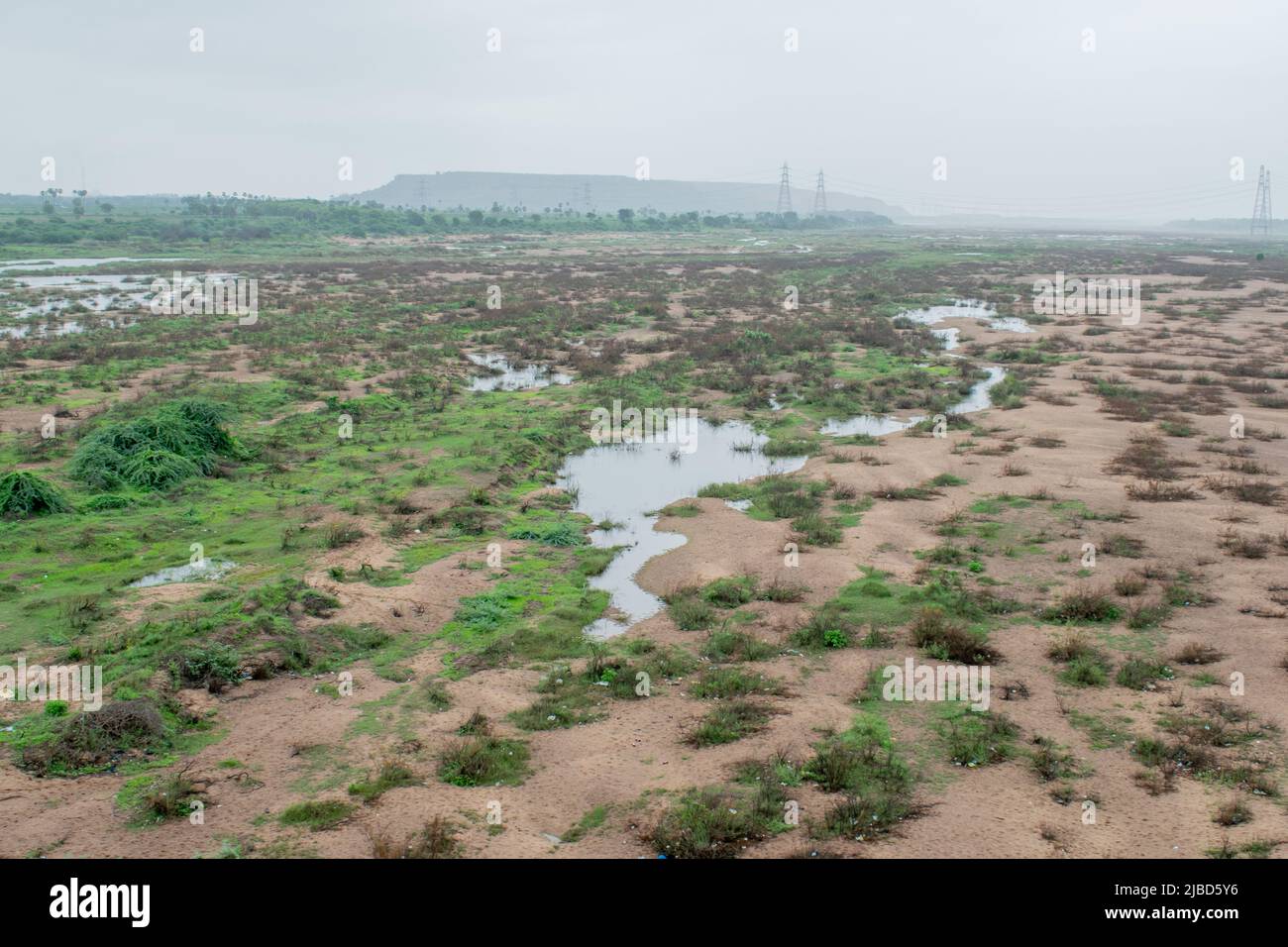 Water is flowing through the land due to small flood Stock Photo - Alamy