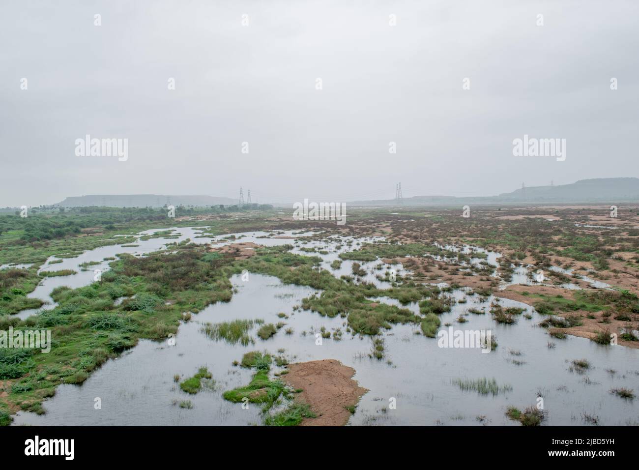 Water is flowing through the land due to small flood Stock Photo - Alamy