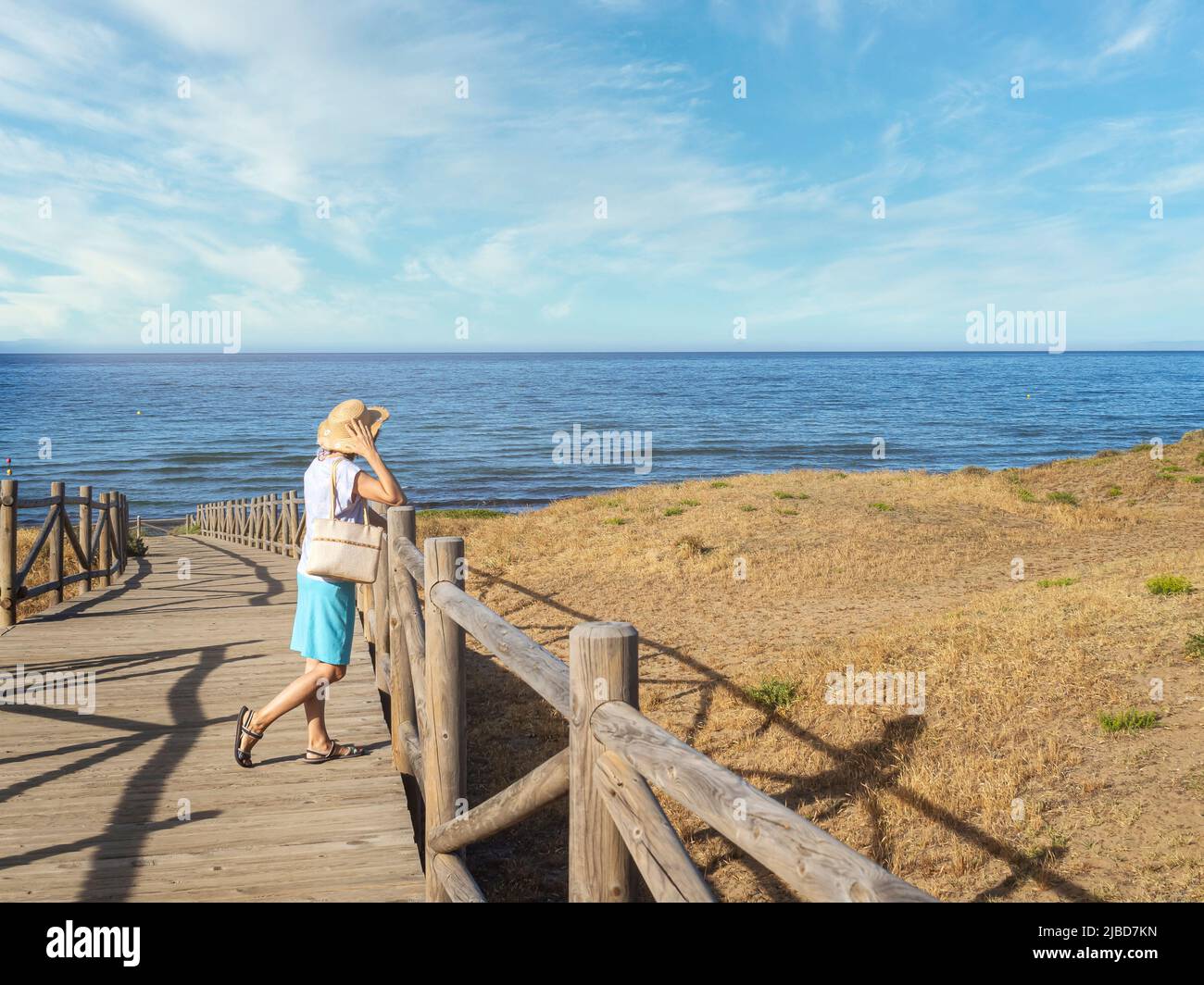 Woman looking at the dunes of Cabo Pino beach, Spain. Summer, vacation ...