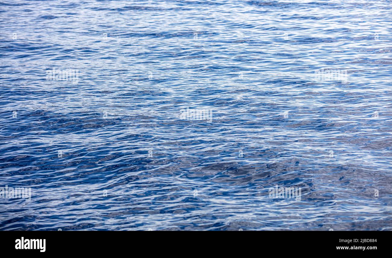 Sea water surface calm with small ripples. Still ocean, deep blue color ...