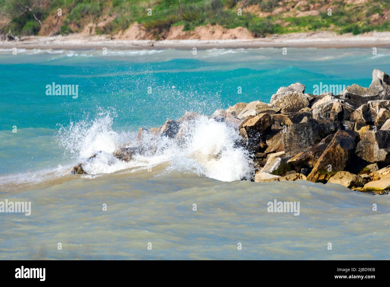 A wave crashes into the break wall at Coral Dock Park in Port ...