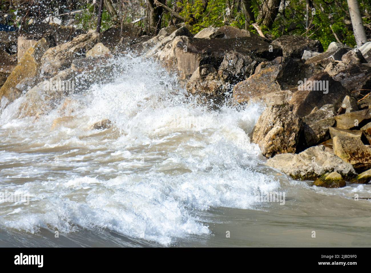 A wave crashes into the break wall at Coral Dock Park in Port ...