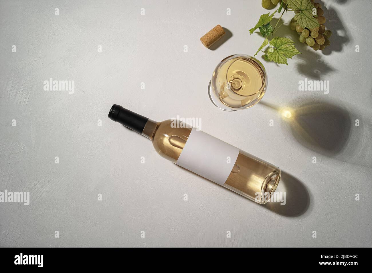Bottle of white wine with label. Glass of wine and grape. Wine bottle ...