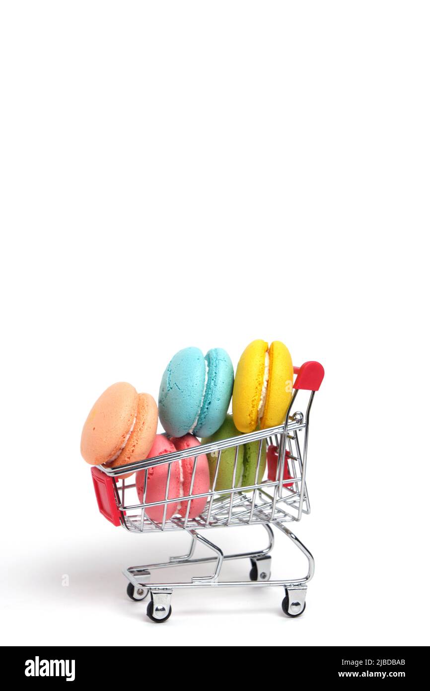 French macarons cookies shopping cart on a white background Stock Photo ...