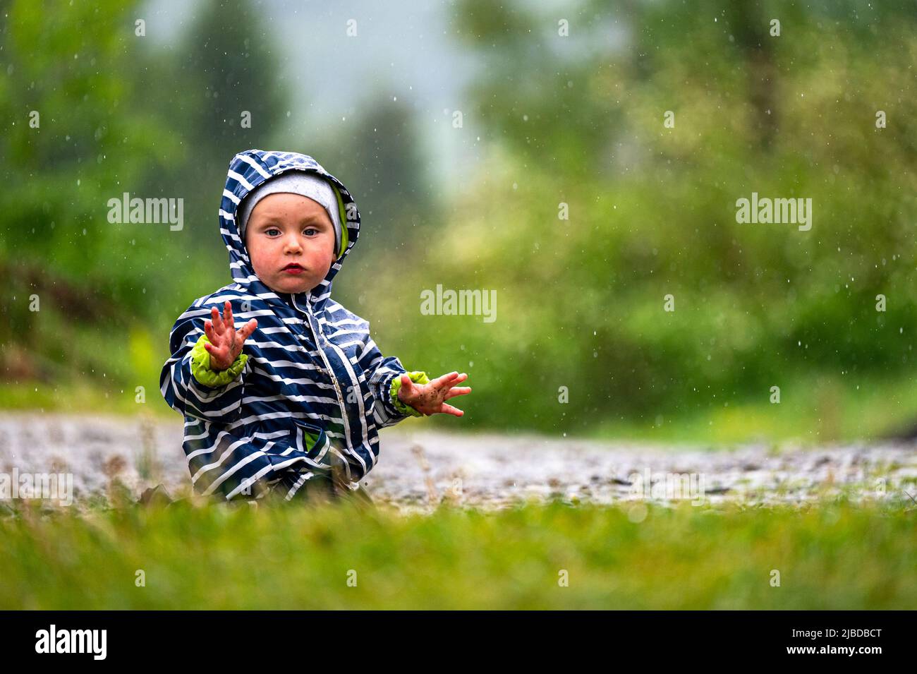 One year old baby playing in the rain Stock Photo - Alamy