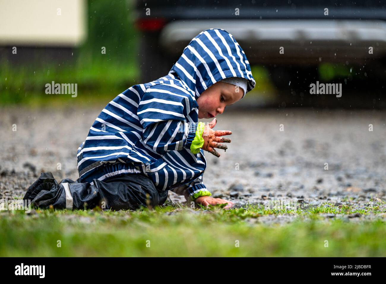 One year old baby playing in the rain Stock Photo - Alamy