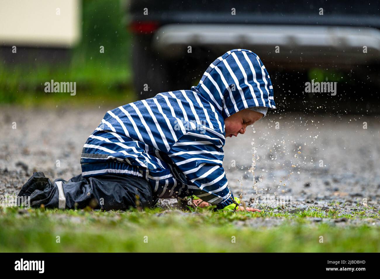 One year old baby playing in the rain Stock Photo - Alamy