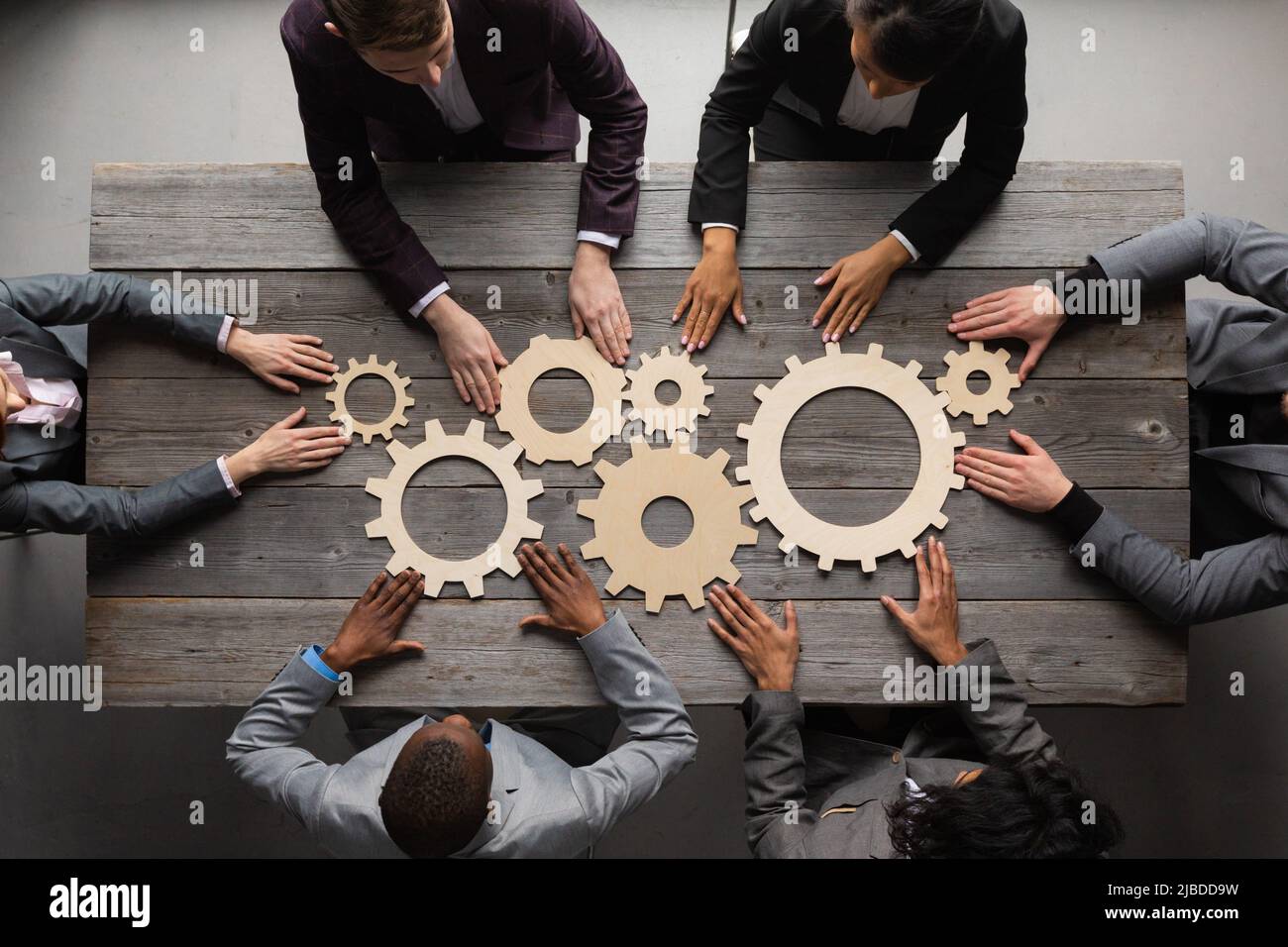 Businessman joining together gears hi-res stock photography and images ...