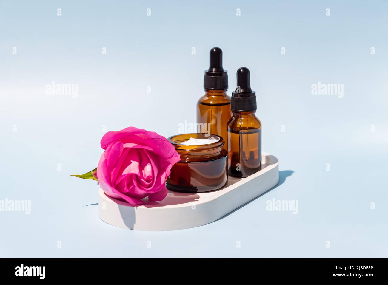 Cosmetics packaging with pink rose. Set of Different cosmetic bottles ...