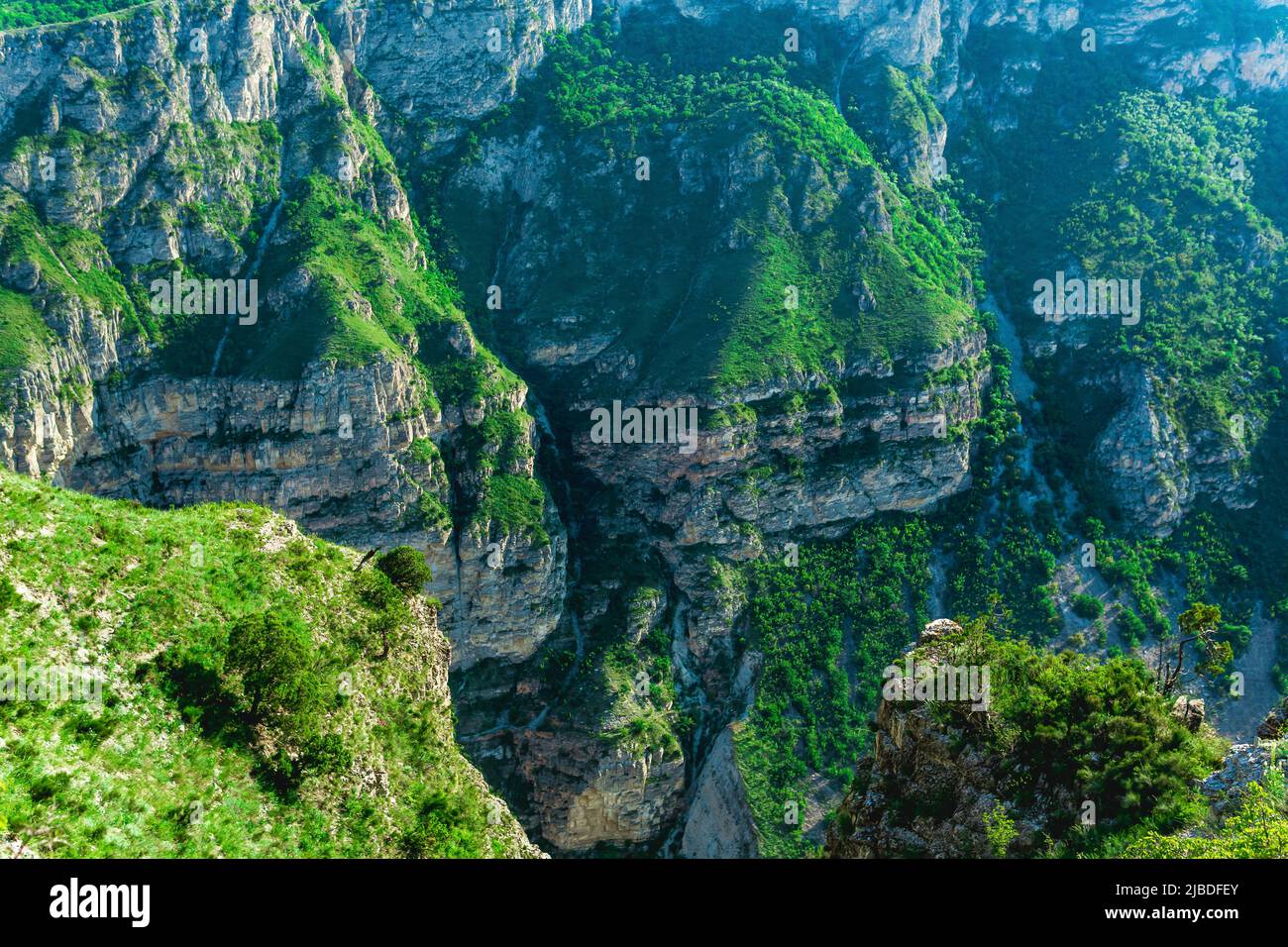 magnificent mountain landscape with green rocky steep slopes of a huge ...
