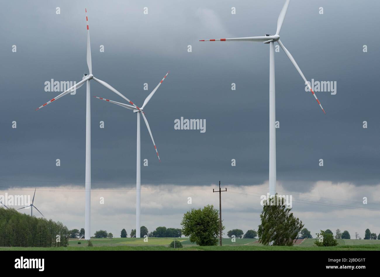 Wind farm in Poland. Windmills in arable fields. Renewable energy ...