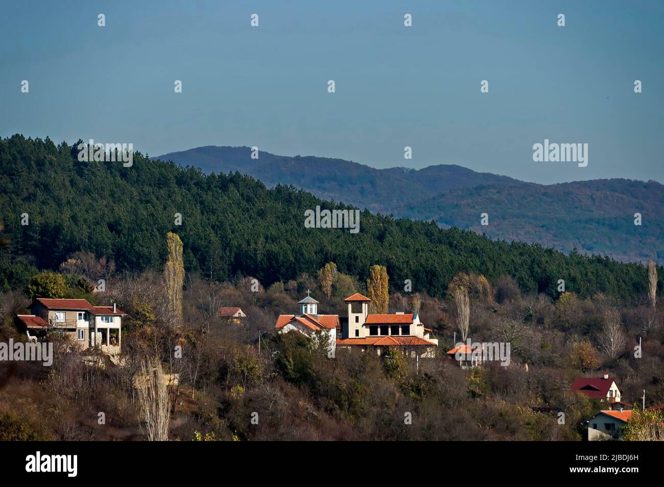 Autumn panorama of part of a residential area with a church with modern architecture and a bell ...