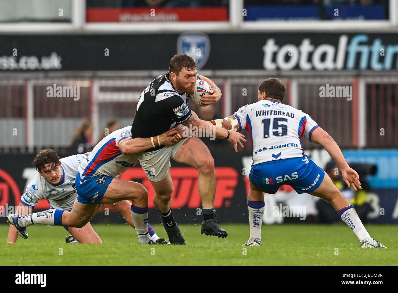 Scott Taylor (30) of Hull FC is tackled by Jay Pitts (13) of Wakefield ...