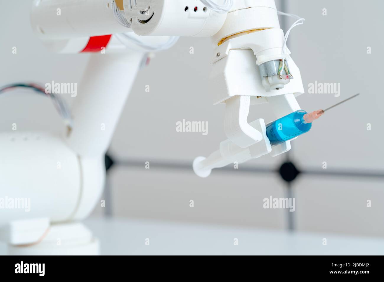 Robot hand with a medical syringe. Future medicine concept using robots ...