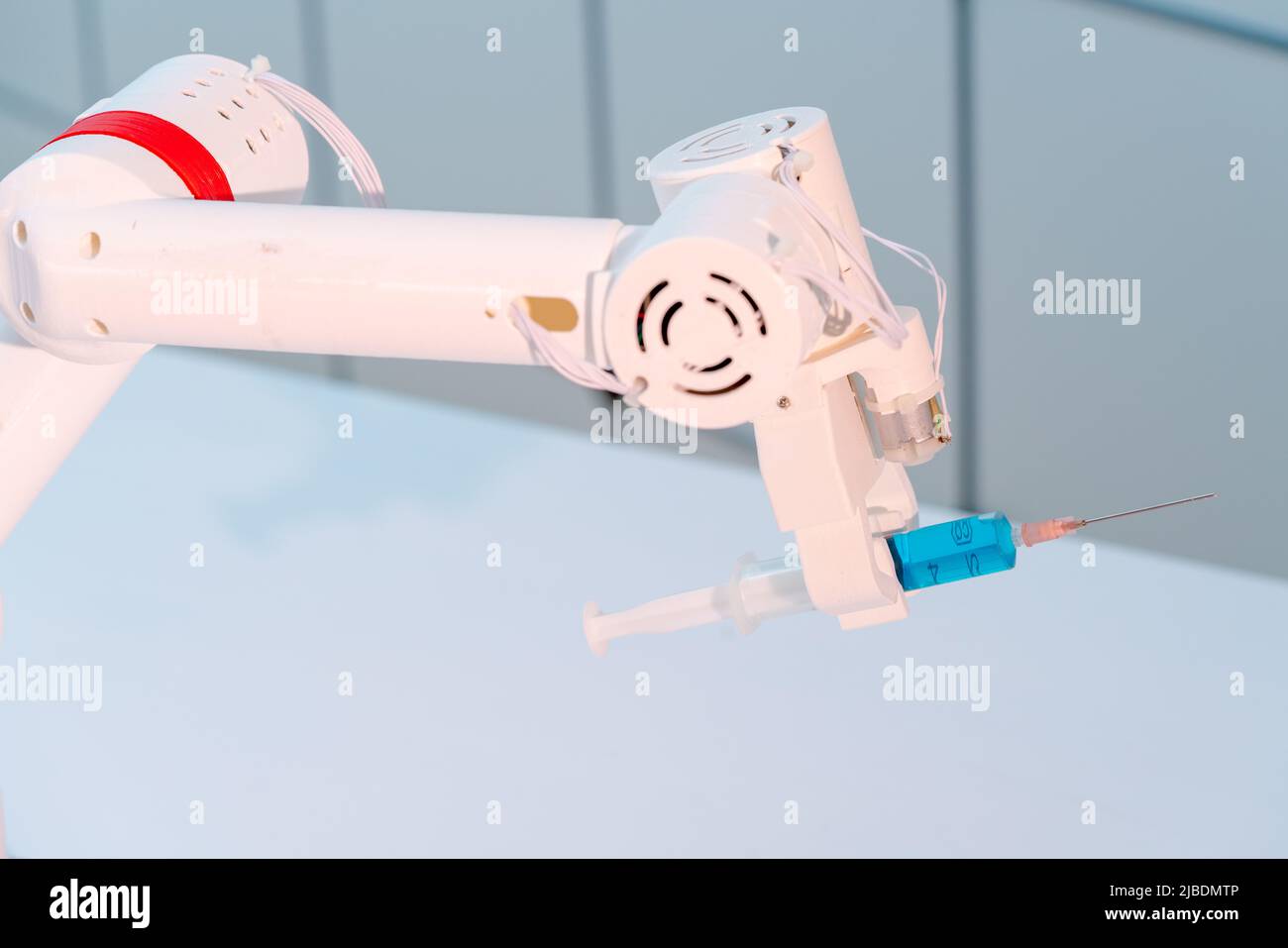 Robot hand with a medical syringe. Future medicine concept using robots ...