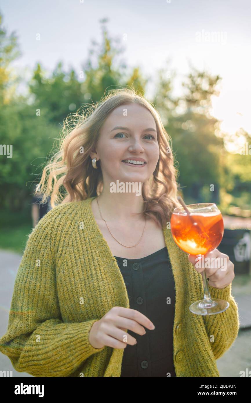 Beautiful European 30s girl having fun in cafe and drinking fruit ...