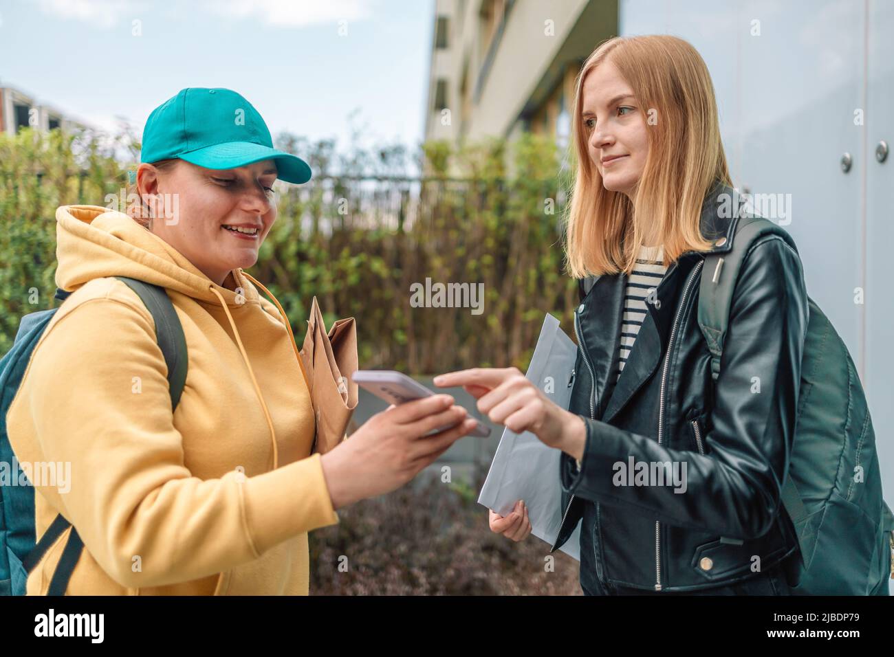 Courier service delivery woman giving paper mail letter parcel to ...
