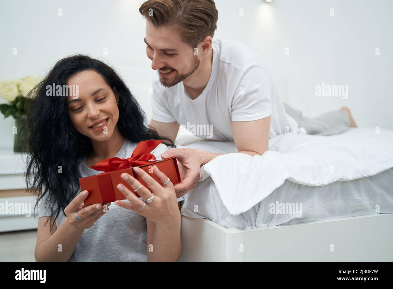 Man in love giving present to female companion Stock Photo - Alamy