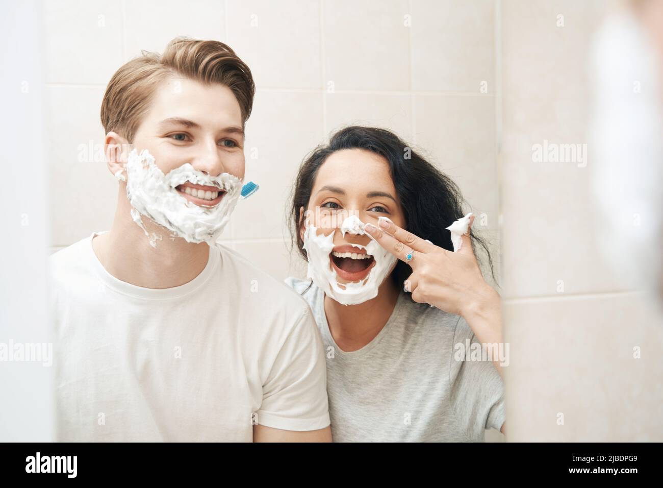 Family couple having fun before bathroom mirror Stock Photo - Alamy