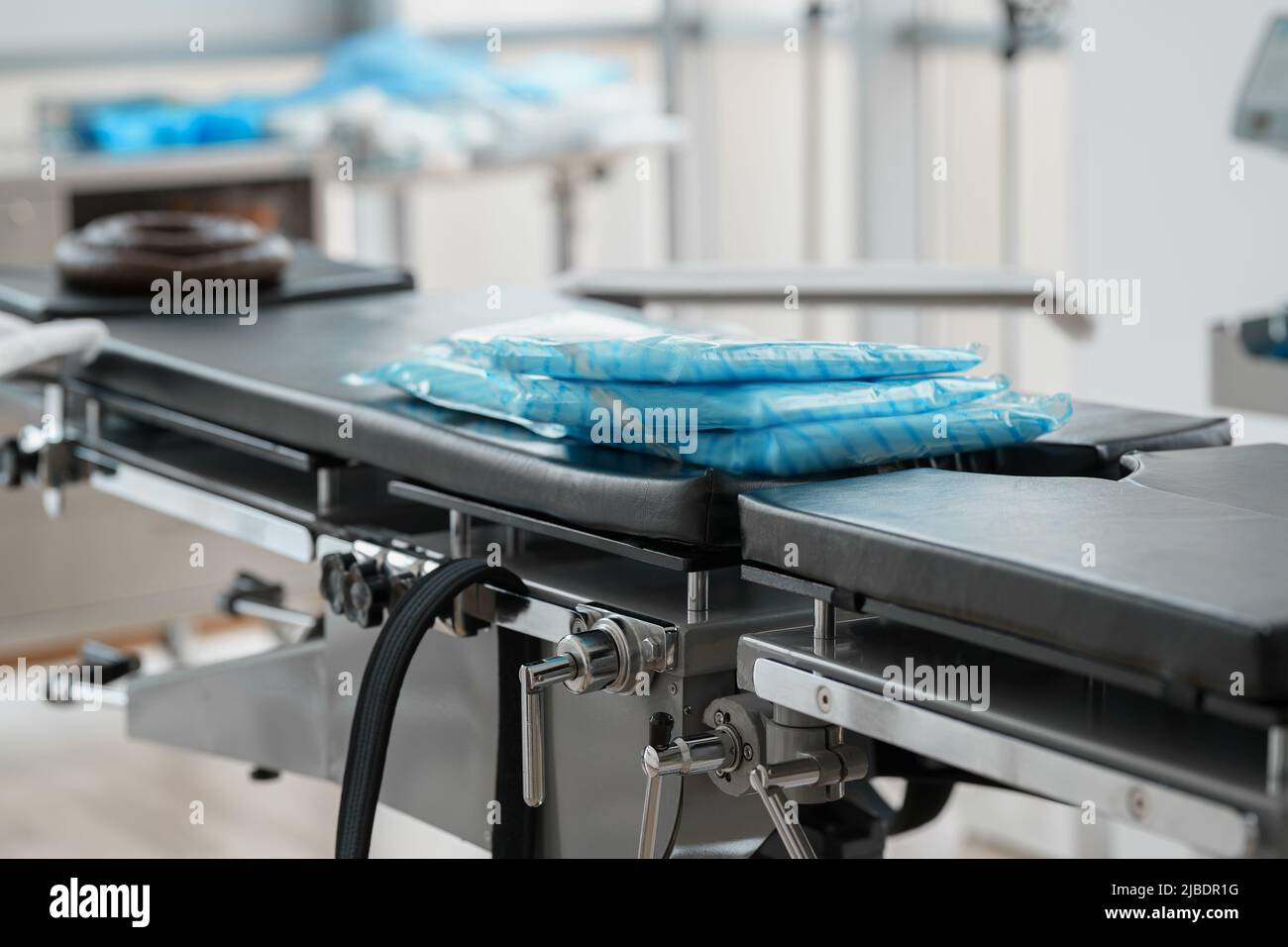 Operating table with medical capes ready for surgery in hospital Stock ...
